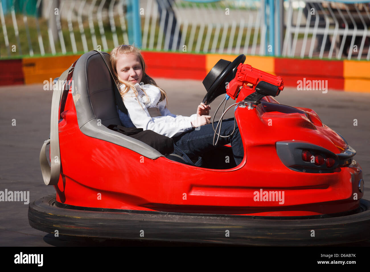 Teenage girl sleeping in a bumper car Stock Photo - Alamy