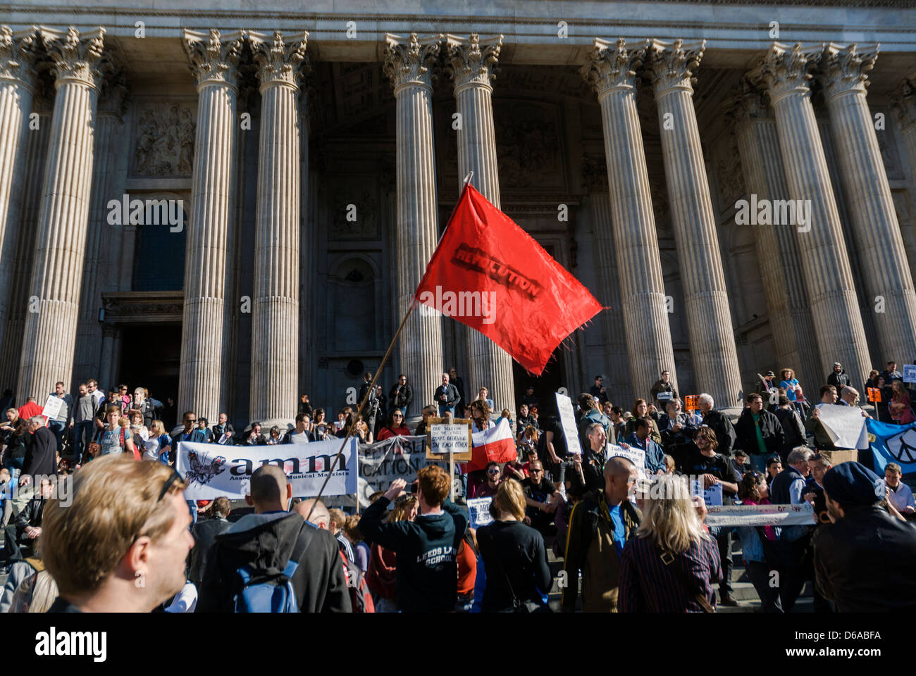 Protesters are carrying red flag at the front of St Paul Cathedral ...