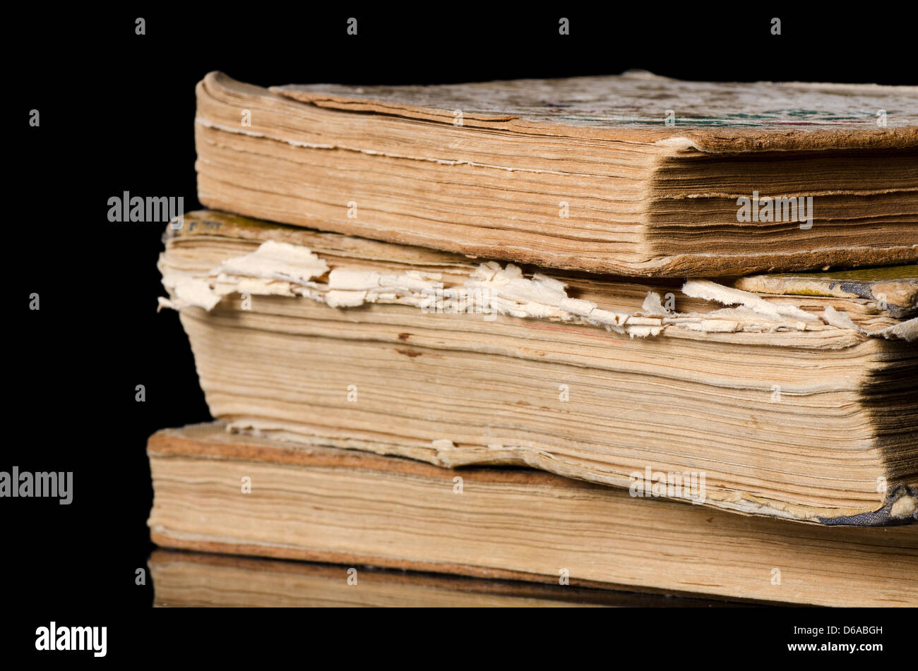 Pile of old books on black Stock Photo - Alamy
