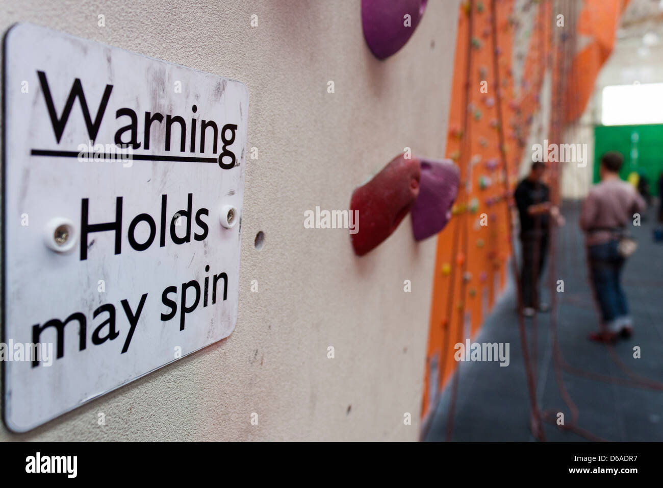 Climbiong holds and warning sign on an indoor climbing wall Stock Photo ...