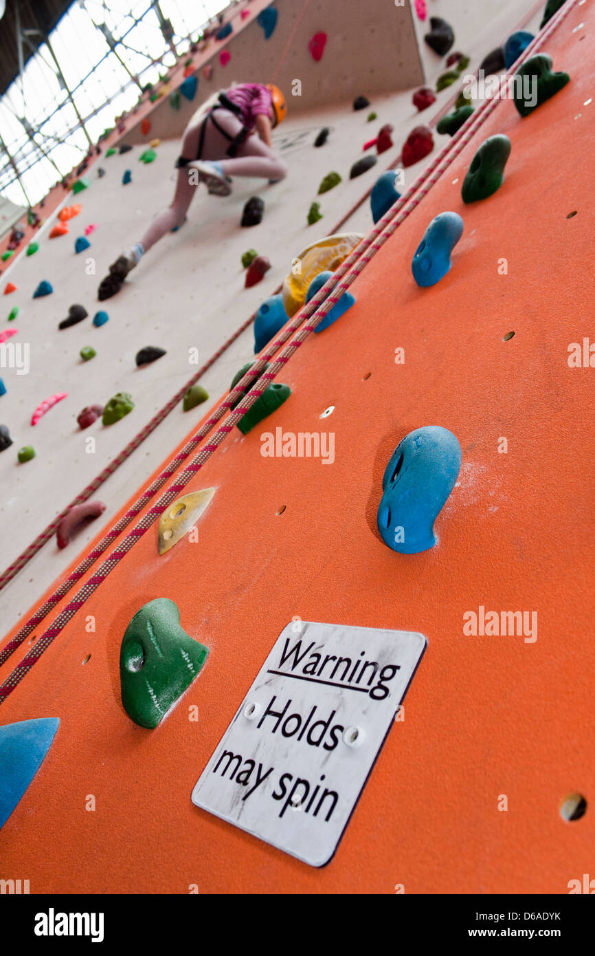 Young children on an indoor climbing wall with warning sign Stock Photo ...