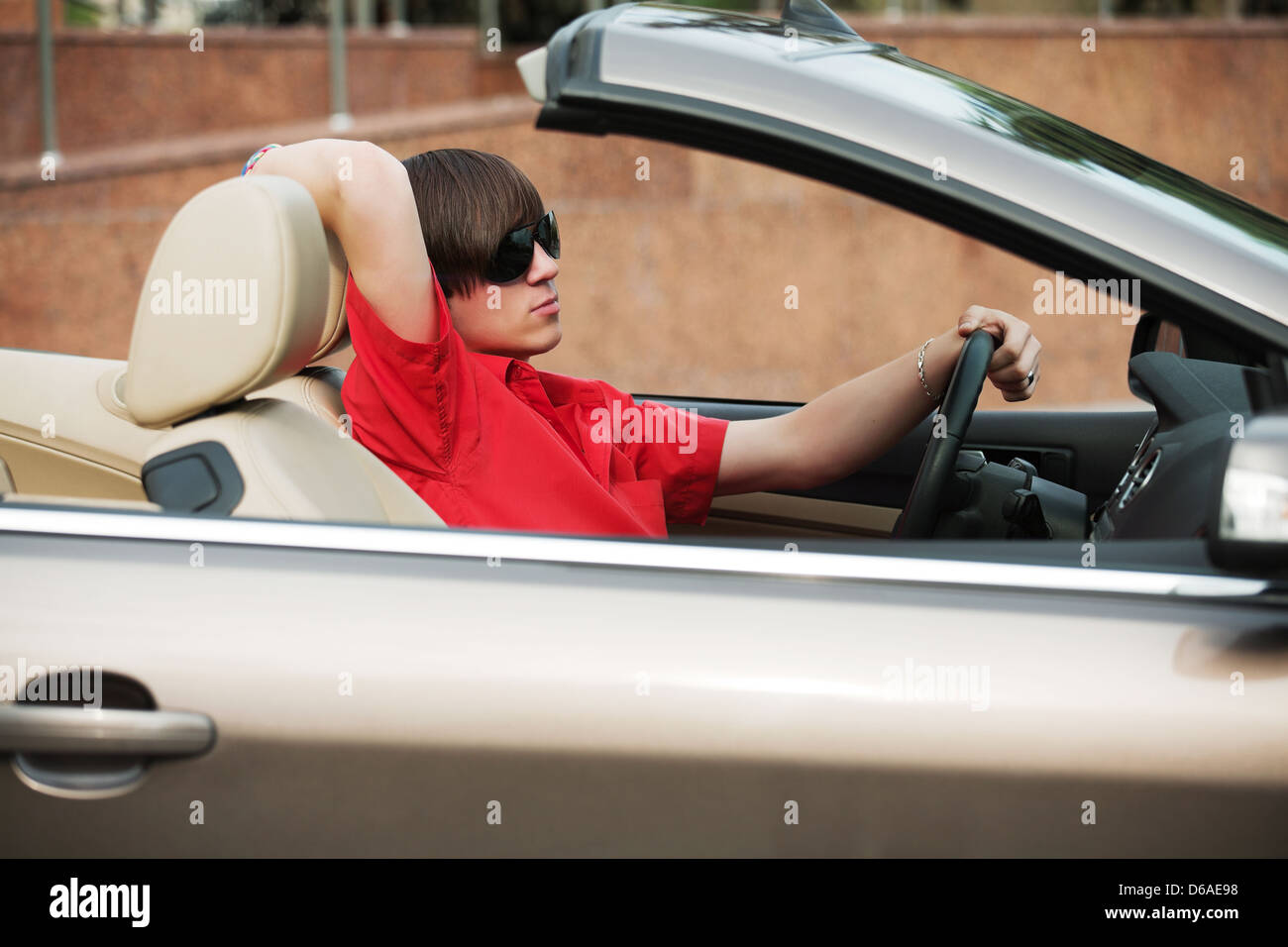 Young man driving a convertible car Stock Photo - Alamy