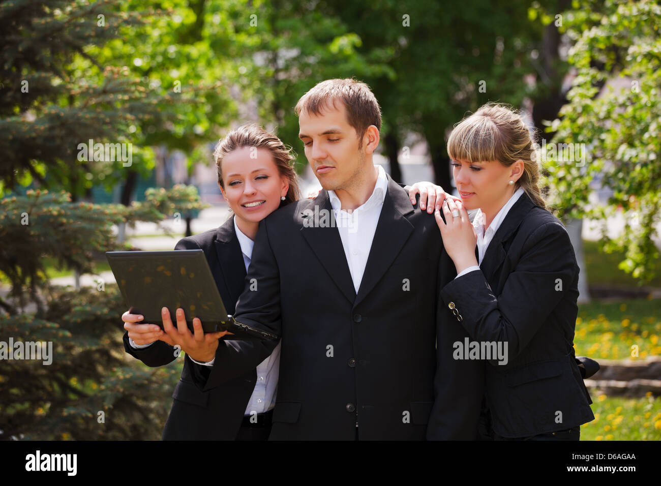 Young business people with laptop Stock Photo - Alamy