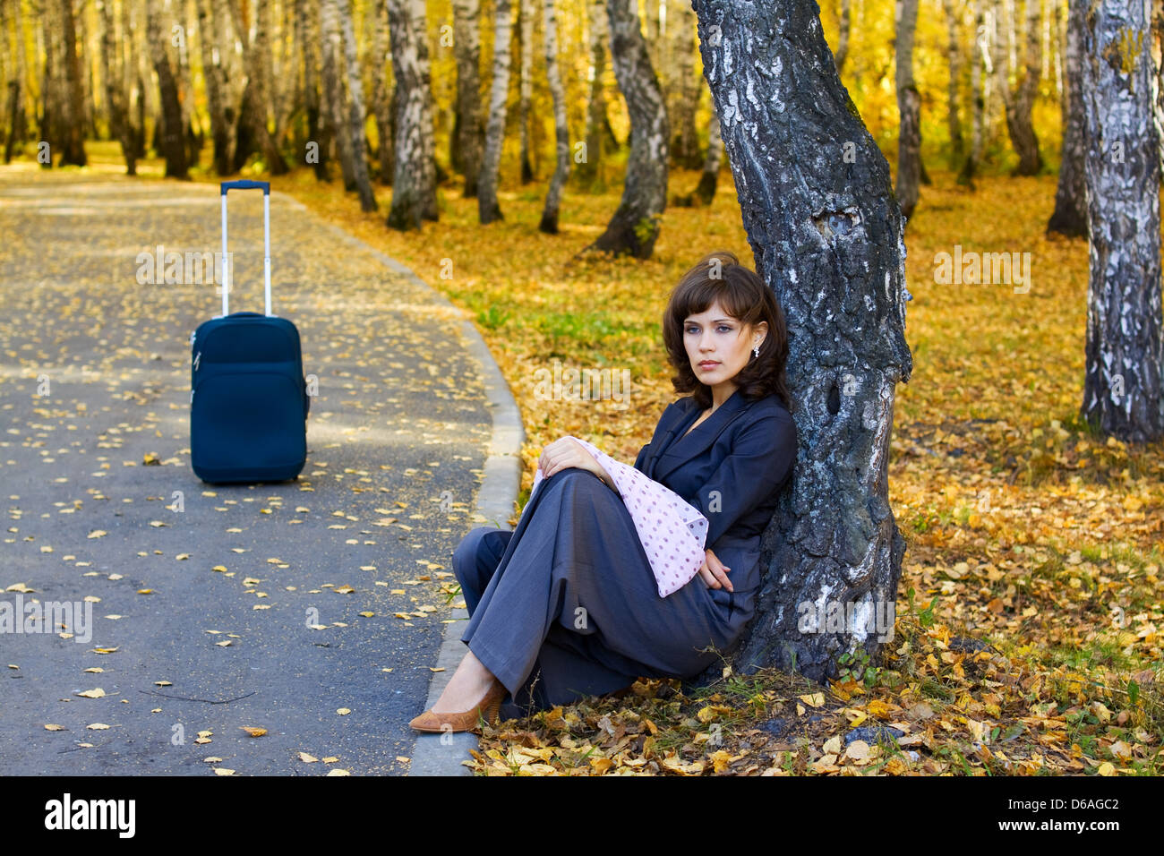 Sad woman with suitcase Stock Photo - Alamy