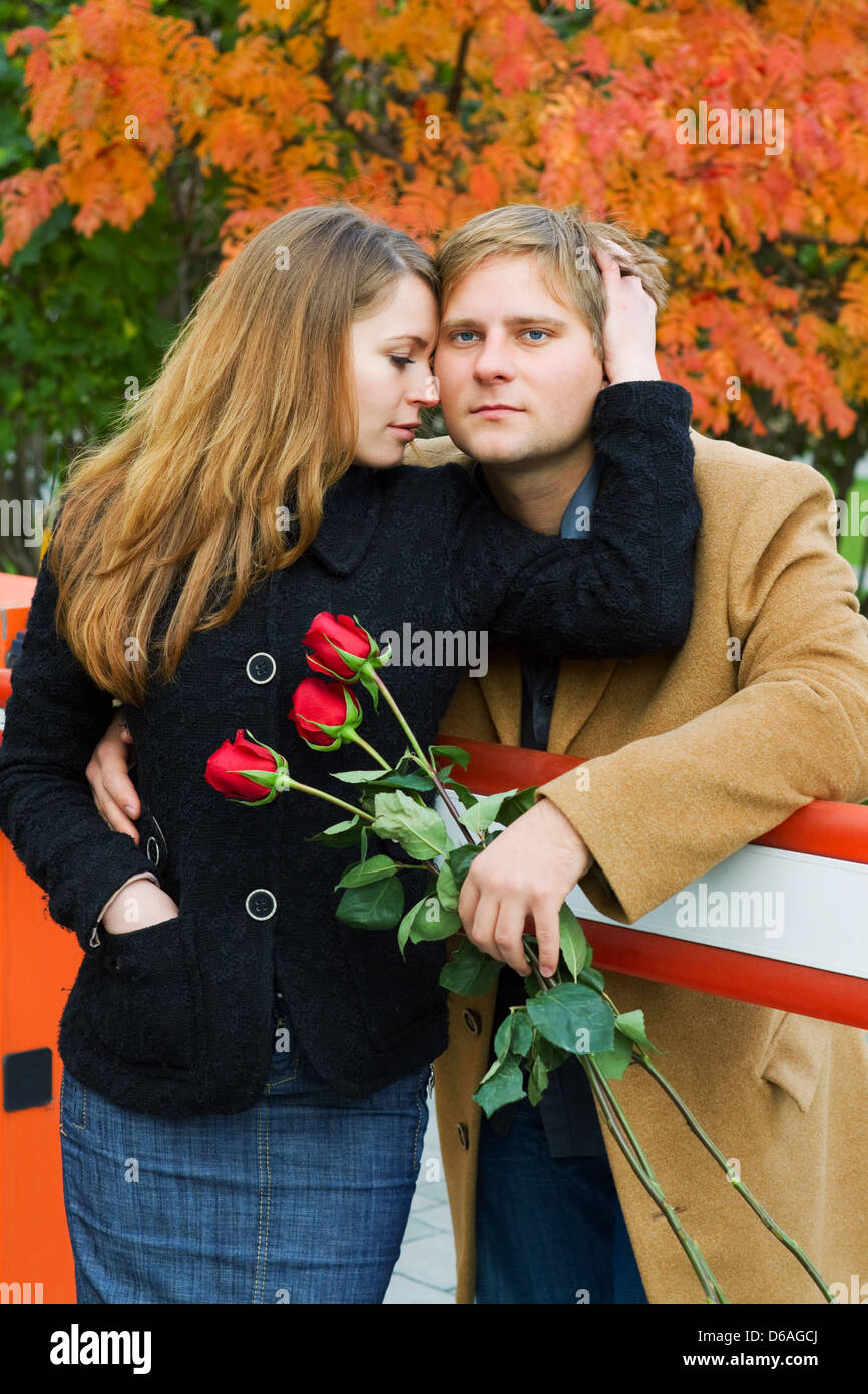 Happy young couple with a roses Stock Photo - Alamy