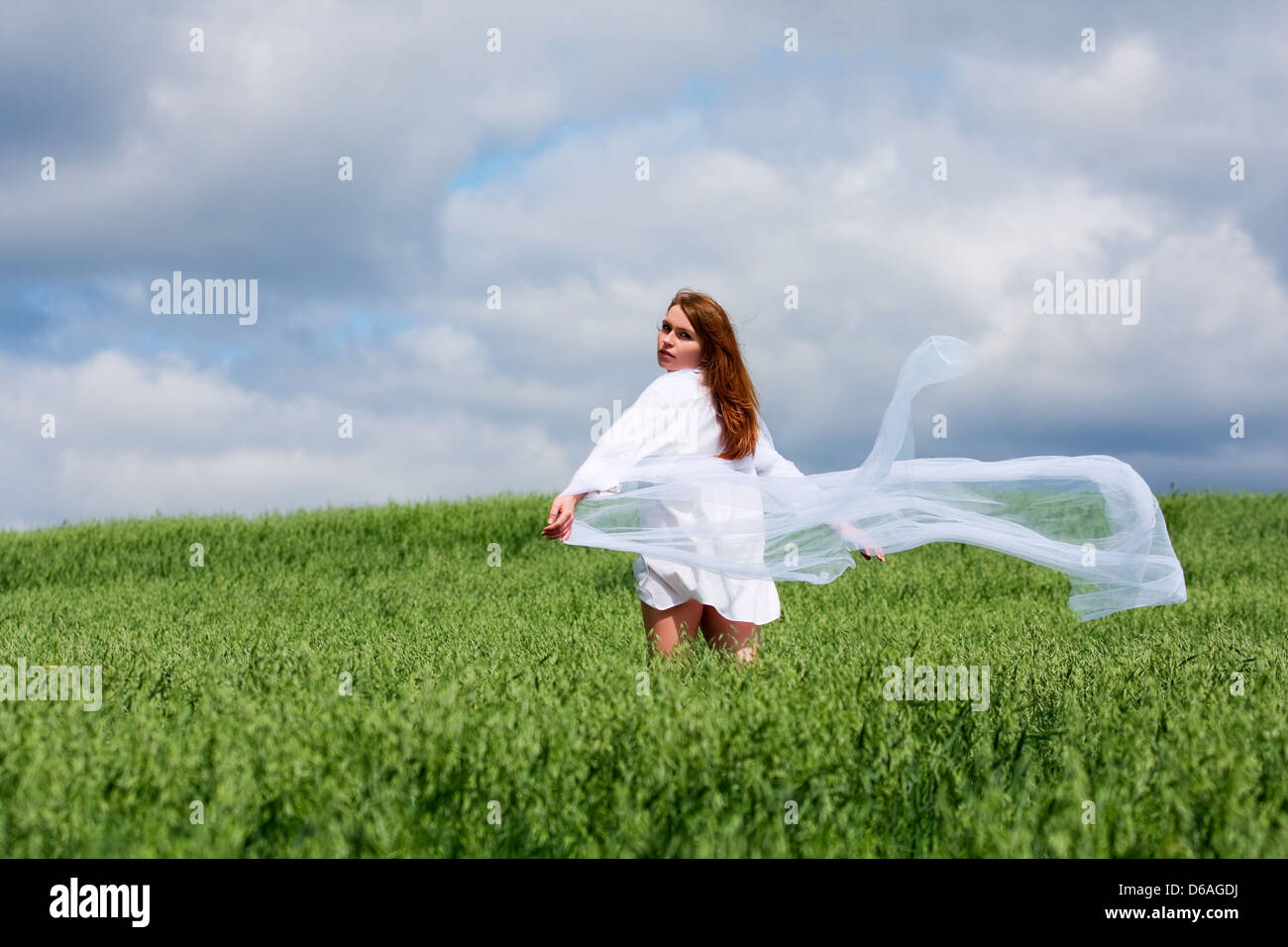 Young woman in a field Stock Photo - Alamy