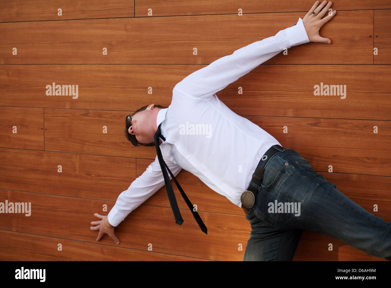 Young man in despair lying on the floor Stock Photo - Alamy