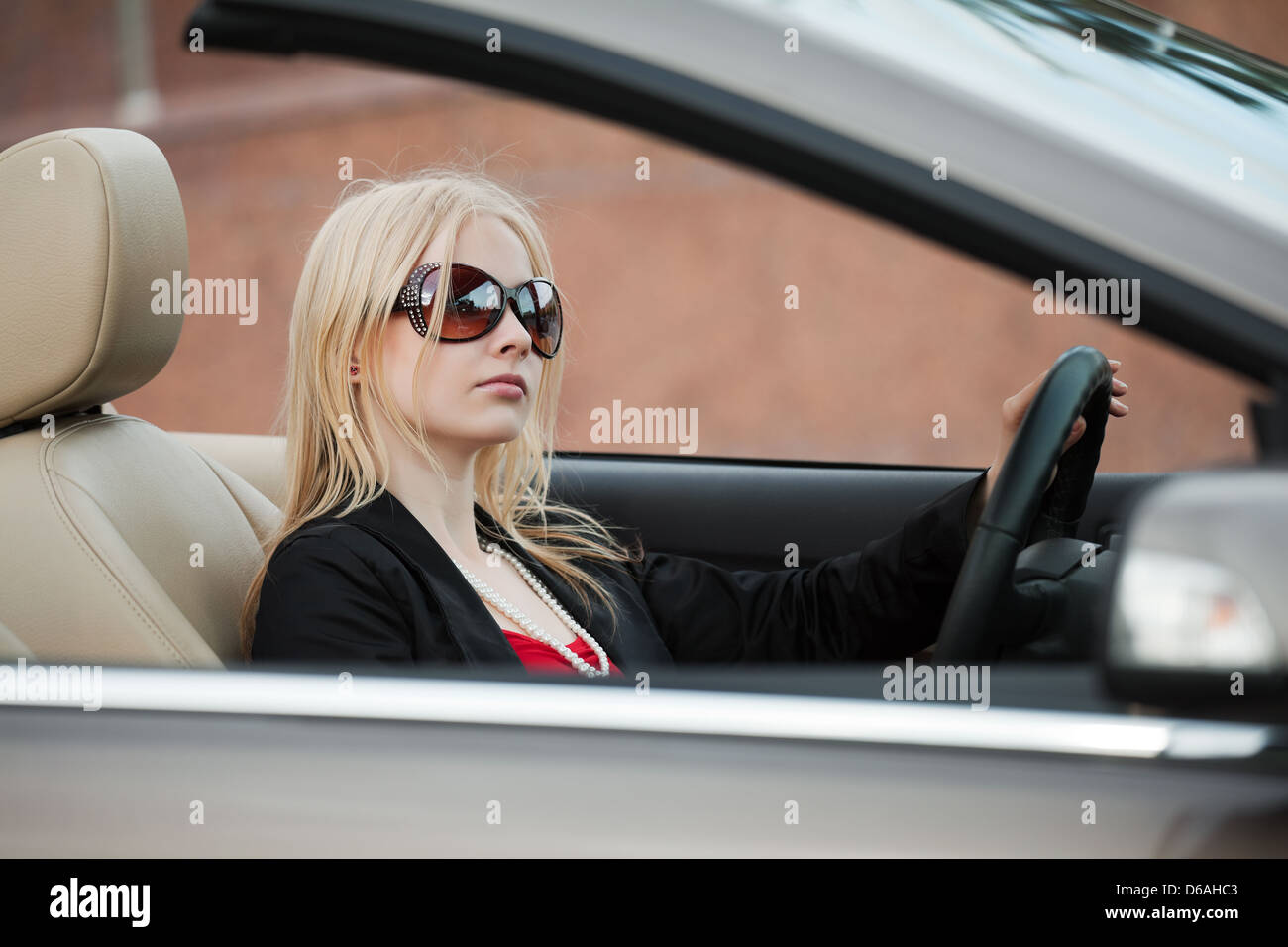 Young woman driving a convertible car Stock Photo - Alamy