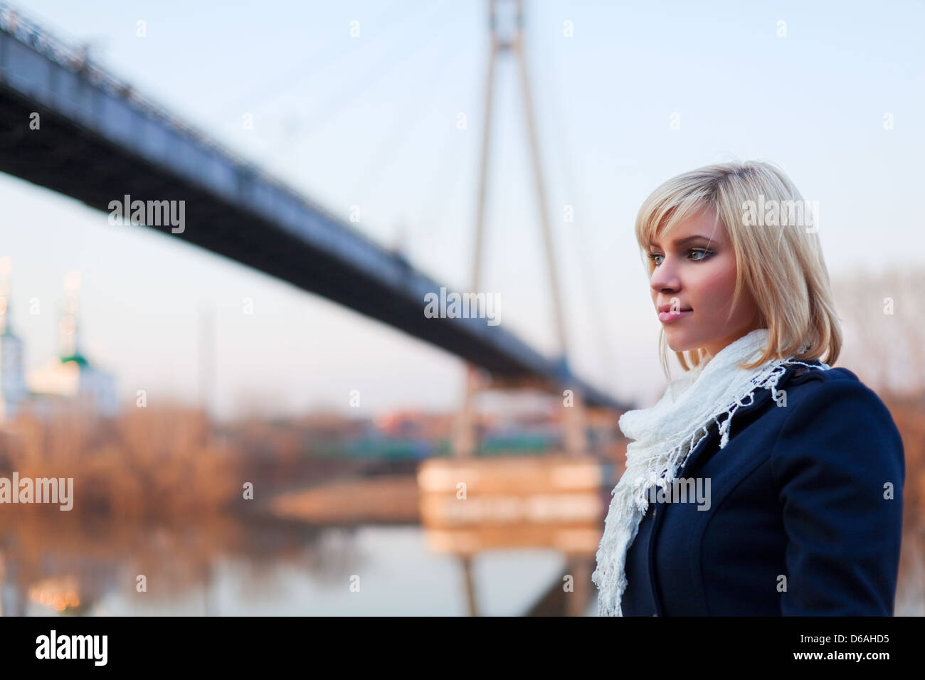 Young woman against a bridge Stock Photo - Alamy