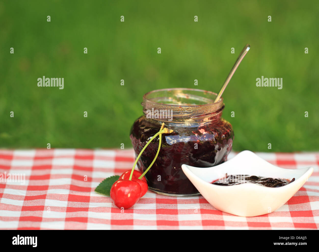 Jar of sweet cherry jam Stock Photo - Alamy
