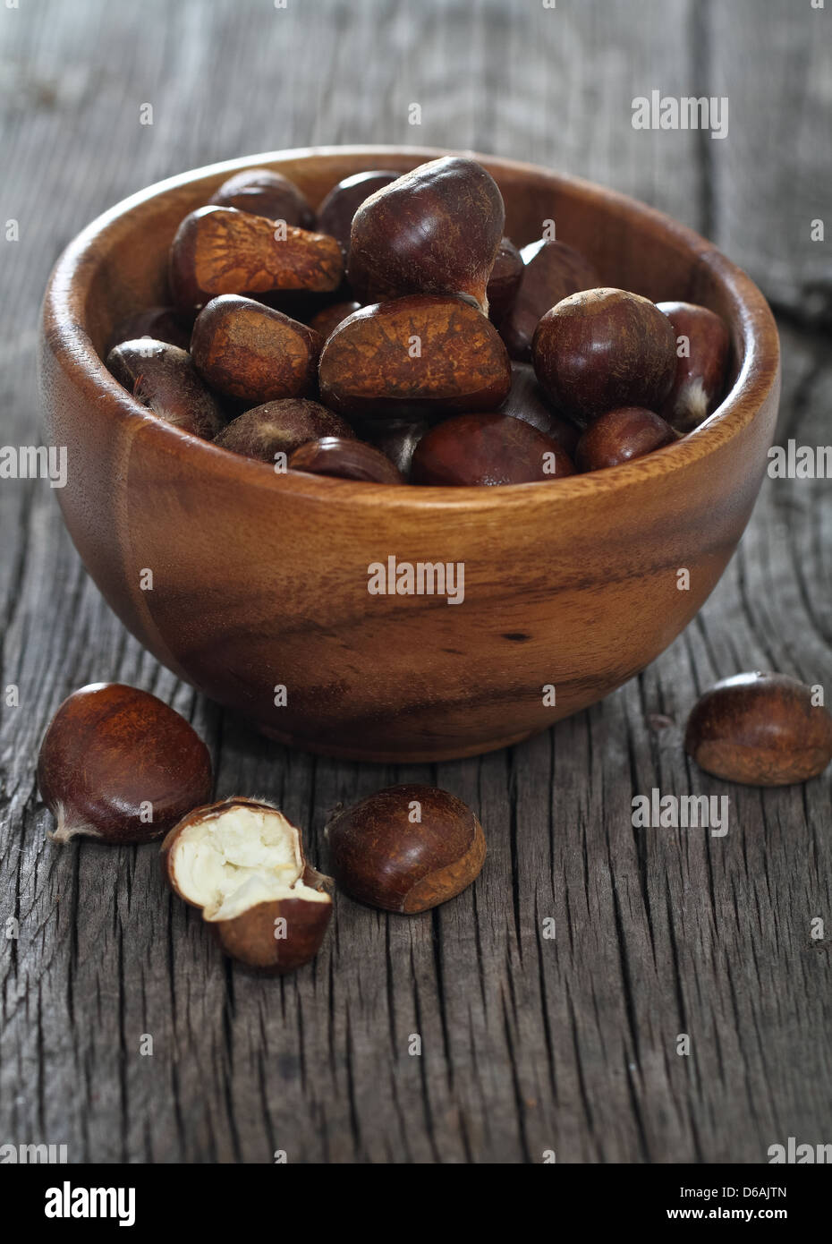 Roasted chestnuts on wooden background Stock Photo - Alamy