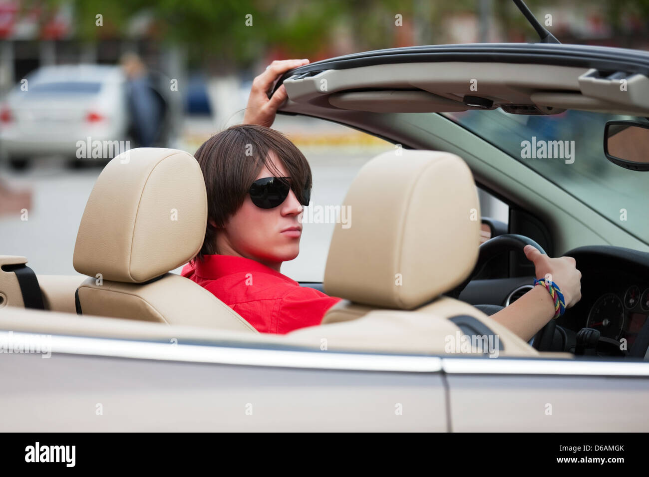 Young man driving a convertible car Stock Photo - Alamy