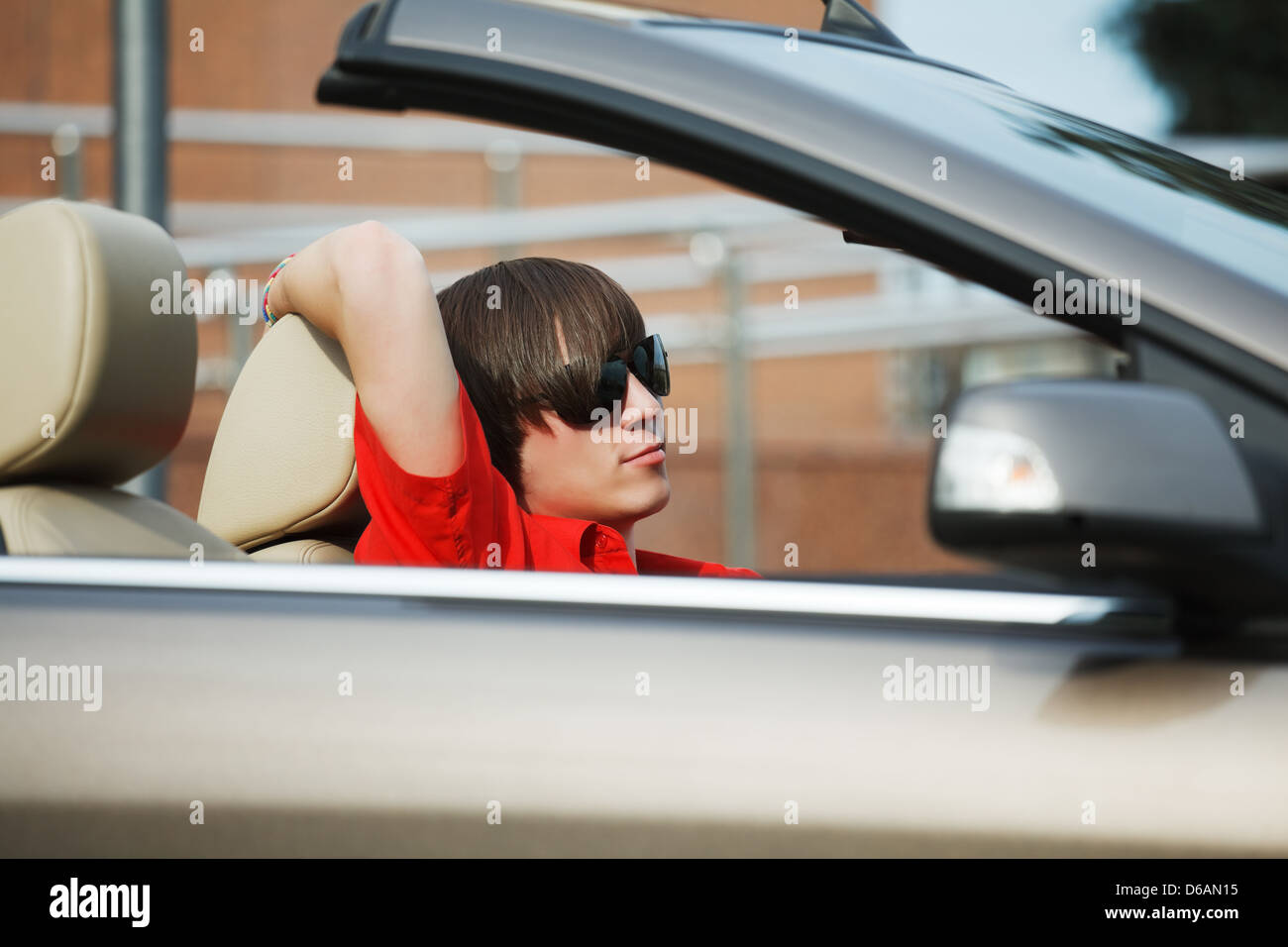 Young man driving a convertible car Stock Photo - Alamy