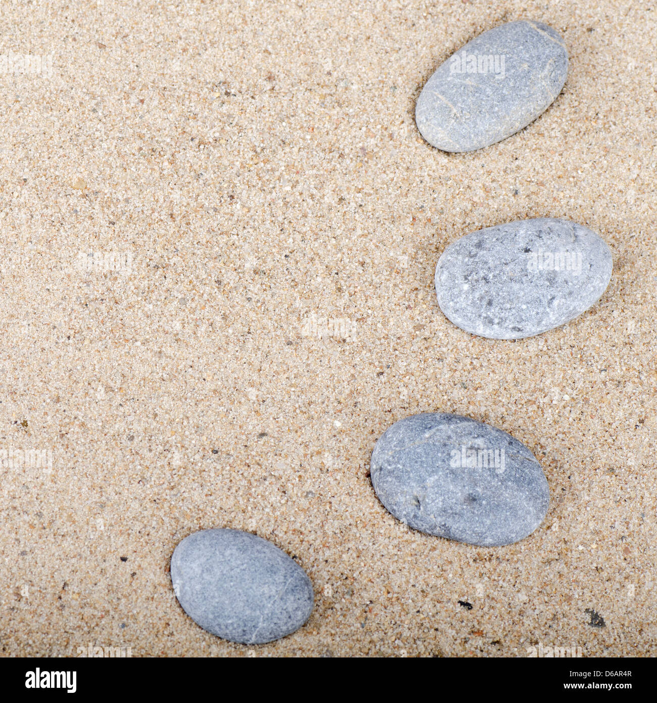 Stones on sand Stock Photo - Alamy