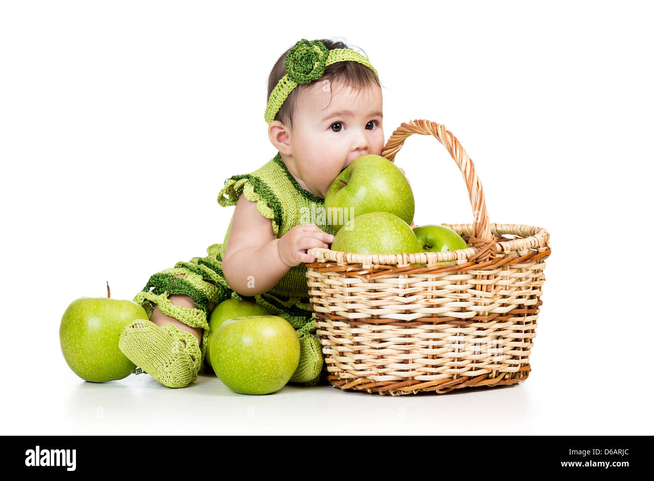 baby eating green apples from basket over white background Stock Photo ...