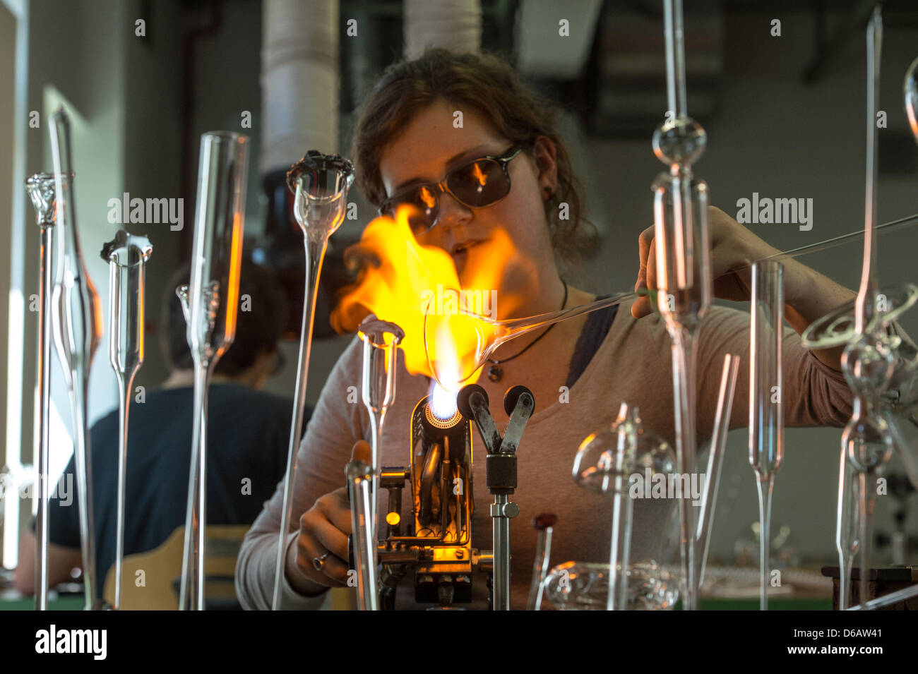 Maria Messerer heats glass over a Bunsen burner at the technical ...