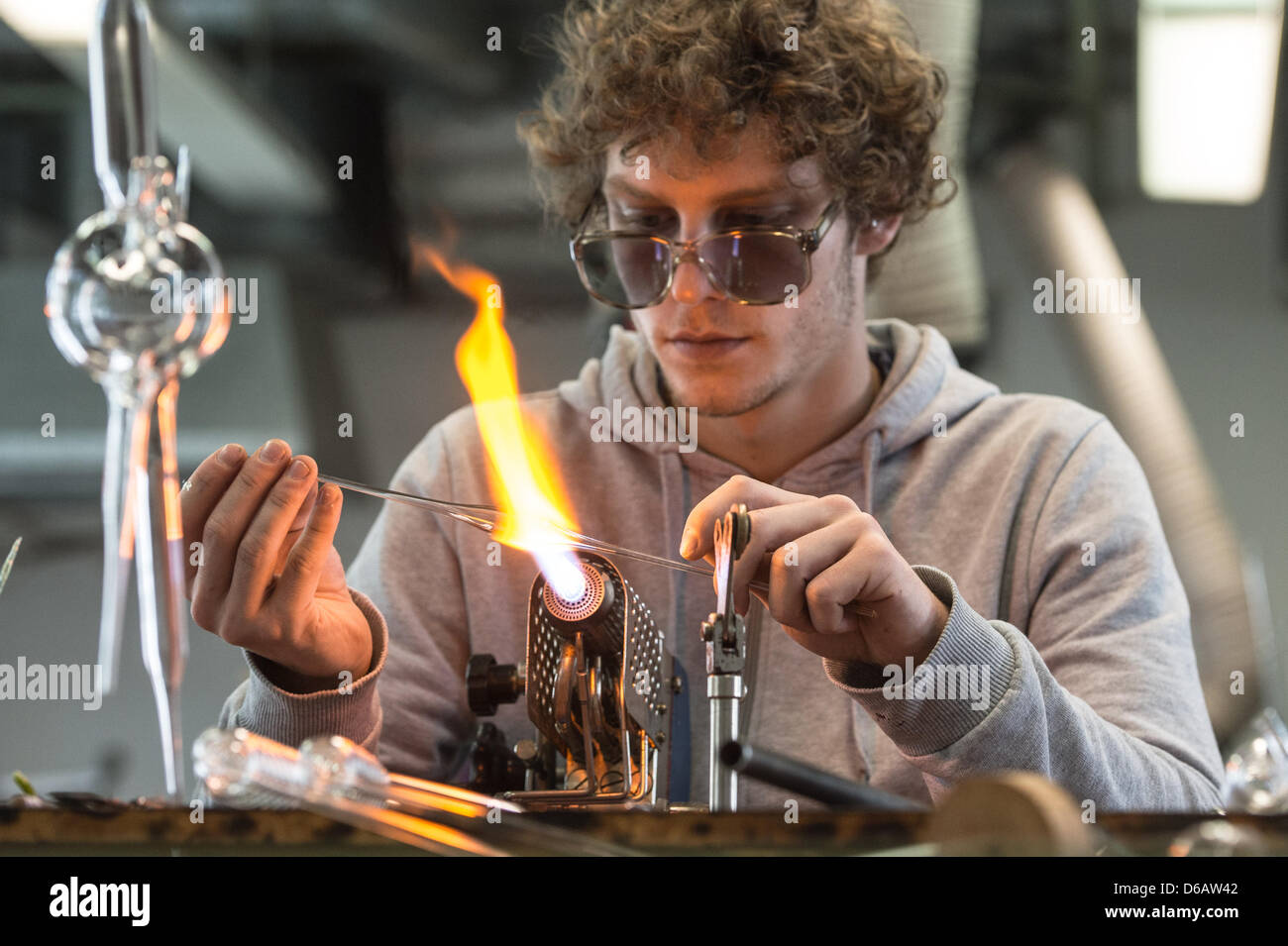 Eric Jacon heats glass over a Bunsen burner at the technical college in ...