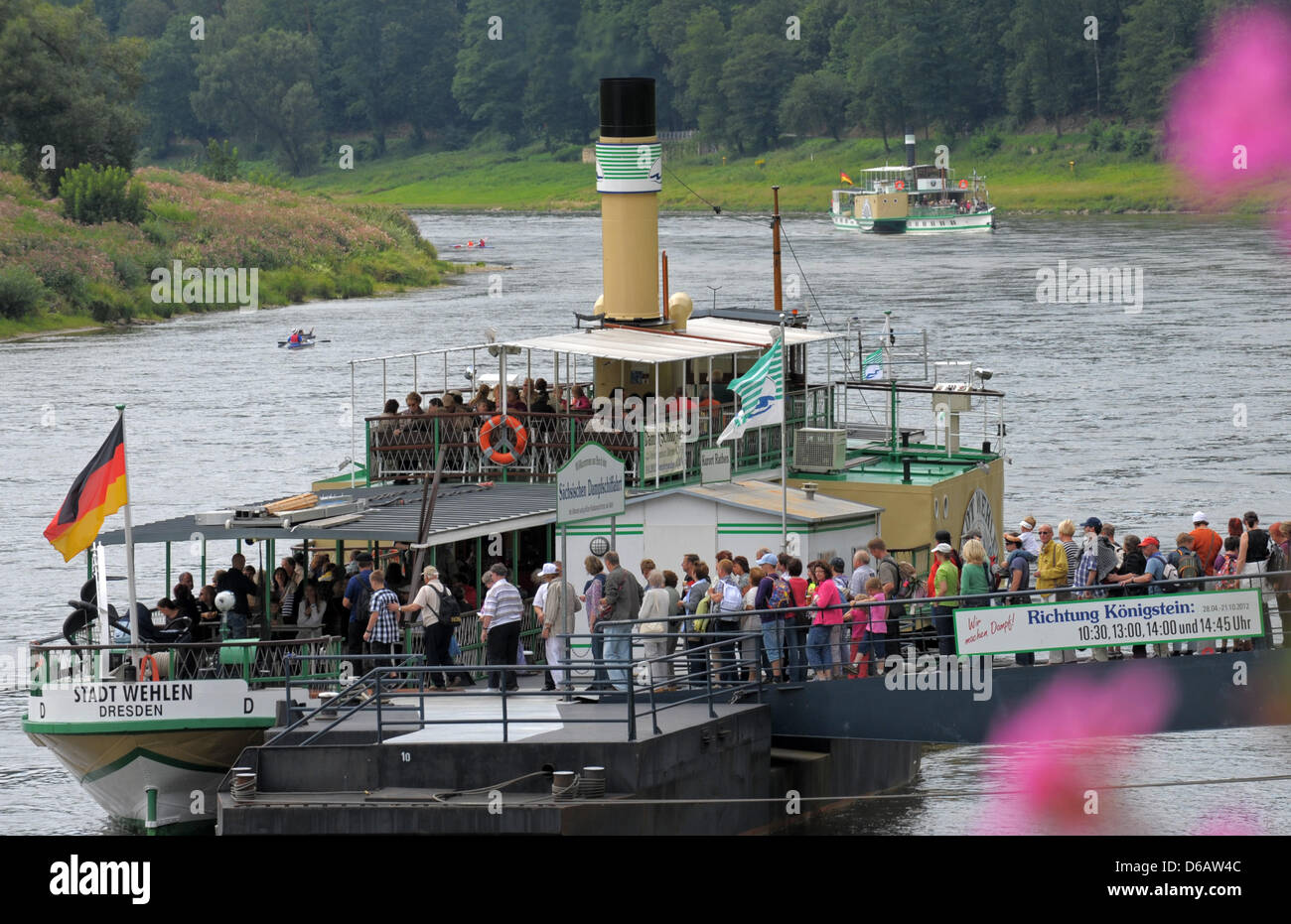 Two historical paddle steamers go along the Elbe river underneath the ...