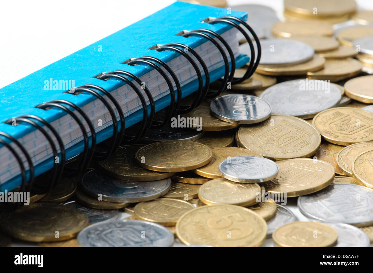 Coins and notebook . close - up Stock Photo - Alamy