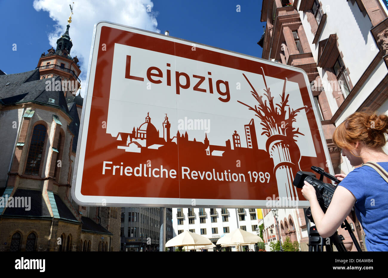 A camera woman films the new Autobahn sign of Leipzig, advertising the ...