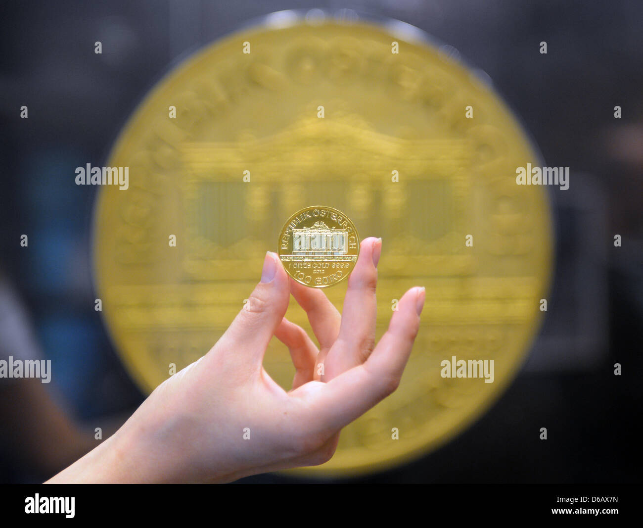 A hand holds Europe's larges gold coin at Pro Aurum in Berlin, Germany ...