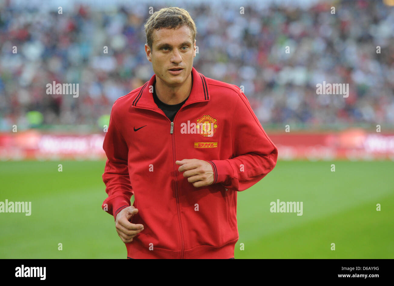 Manchester's Nemanja Vidic warms up prior to the friendly soccer match ...