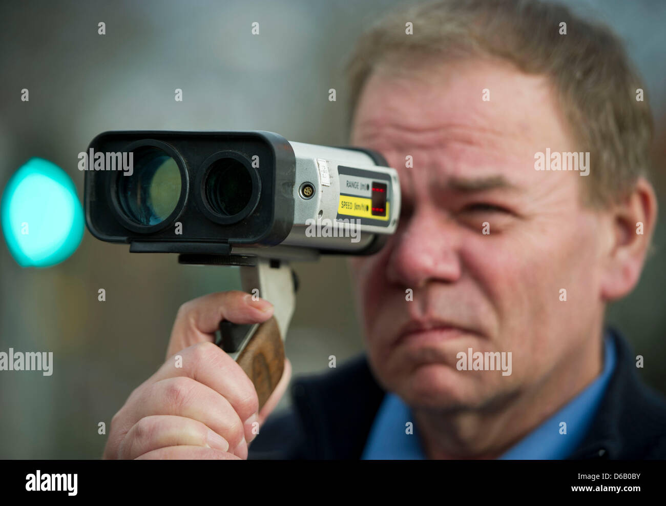 A police officer controls the speed of car drivers with a laser device ...