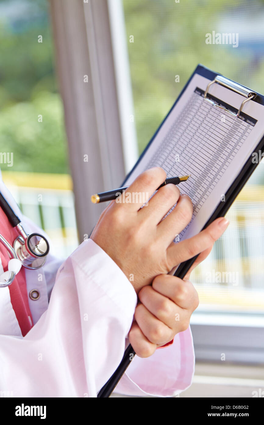 Doctor holding pen and clipboard with checklist in a hospital Stock ...