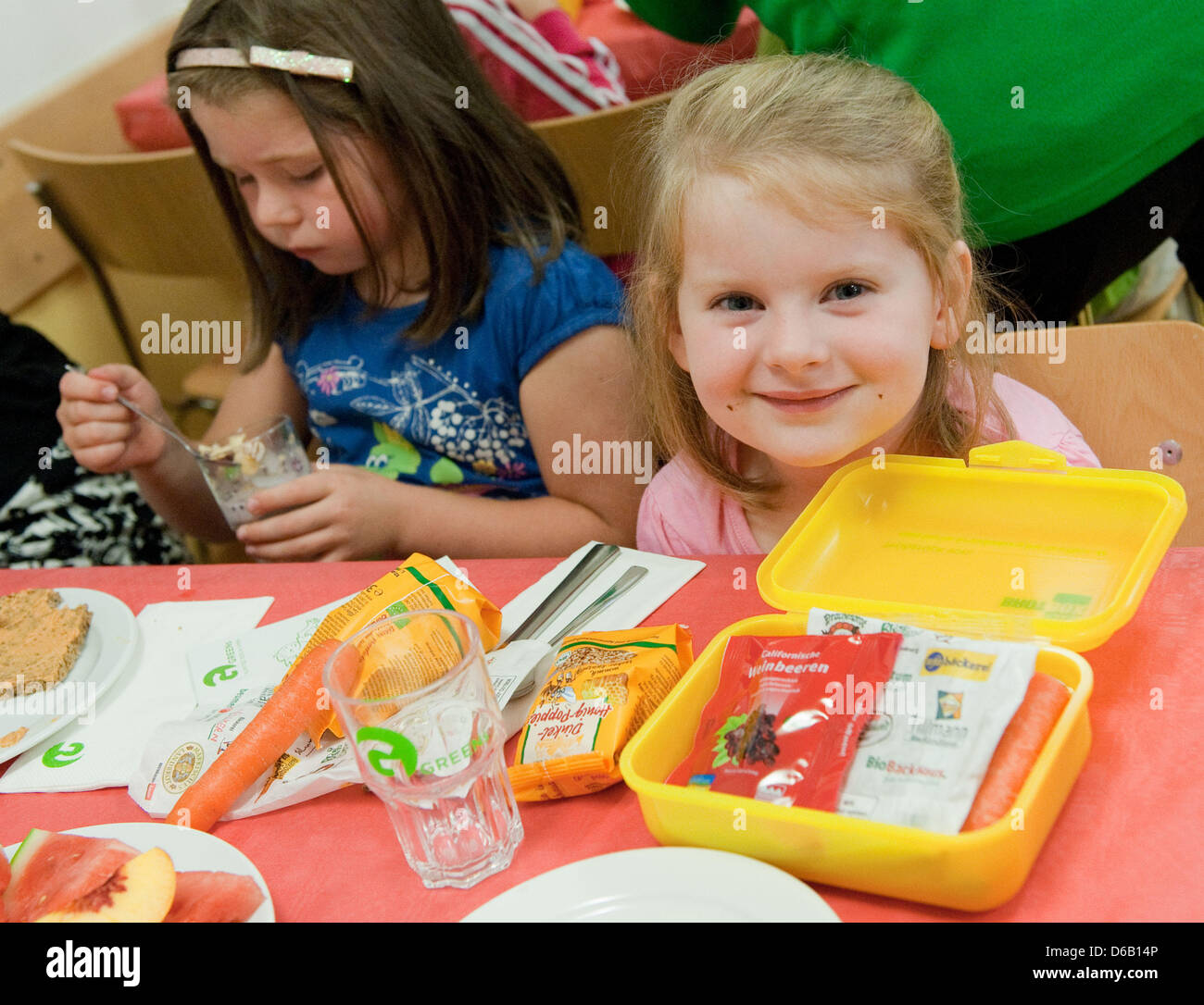 Six-year-old first graders Lucia (L) and Veronika have breakfast at the ...