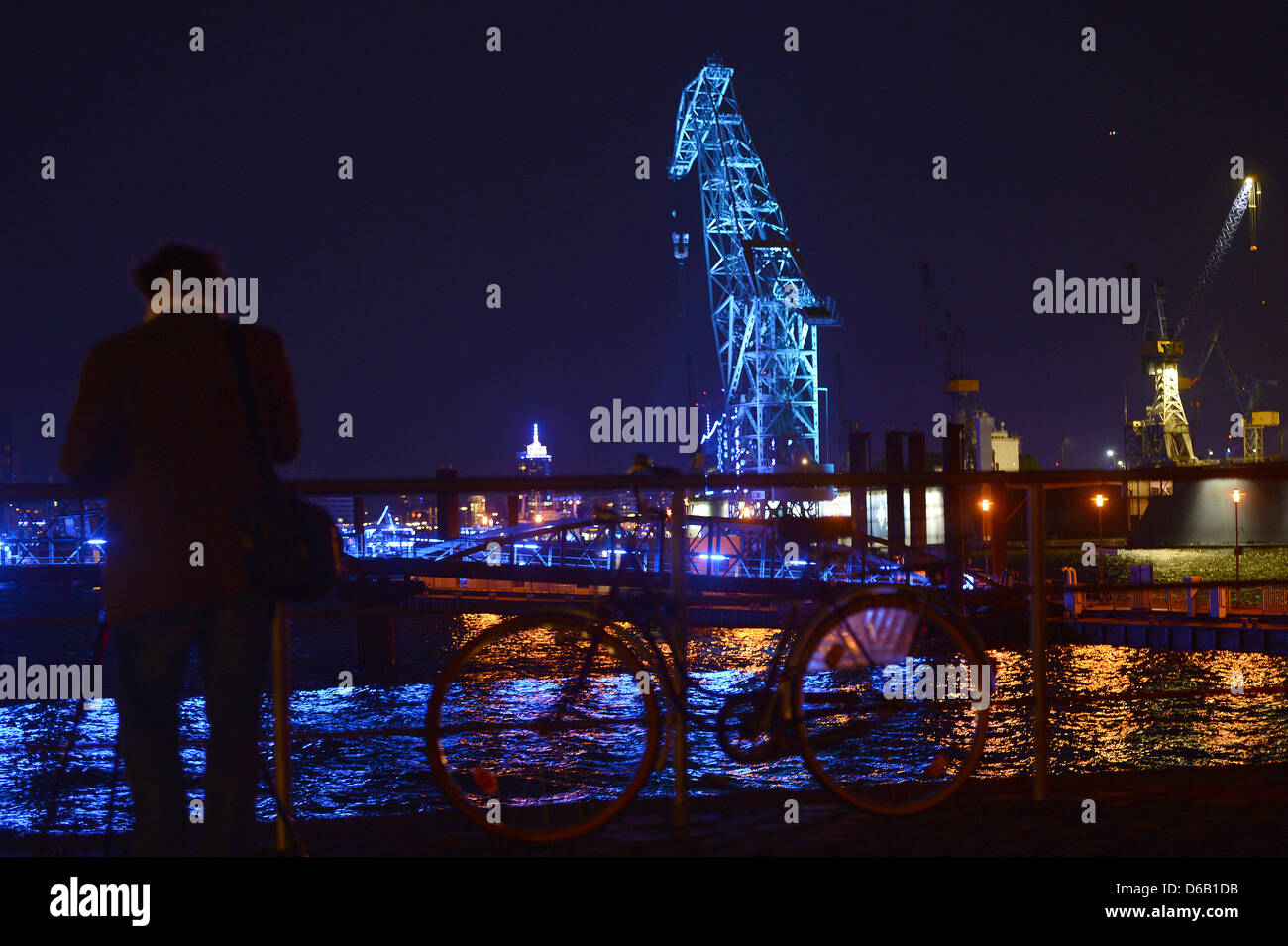A swimming crane is illuminated in blue light in Hamburg, Germany, 13 ...
