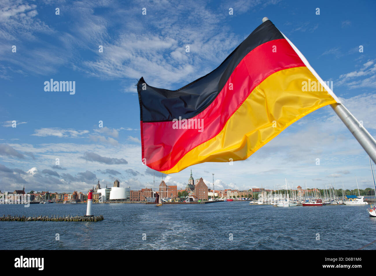 The German flag waves on a ship of the shipyard Hiddensee in front of ...