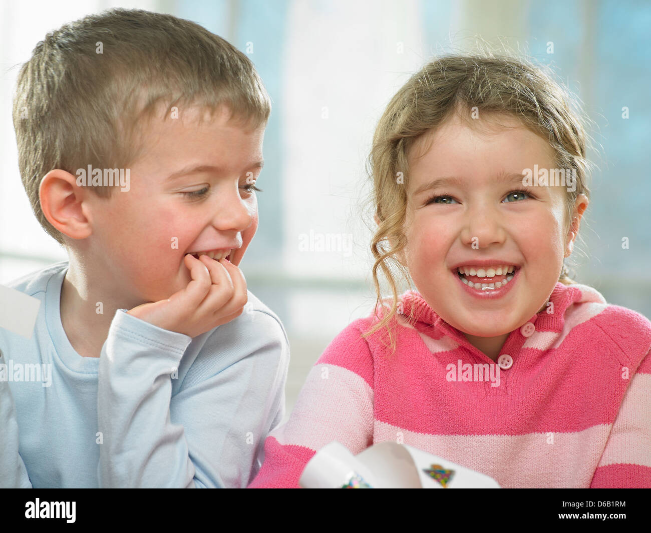 Children laughing together indoors Stock Photo - Alamy