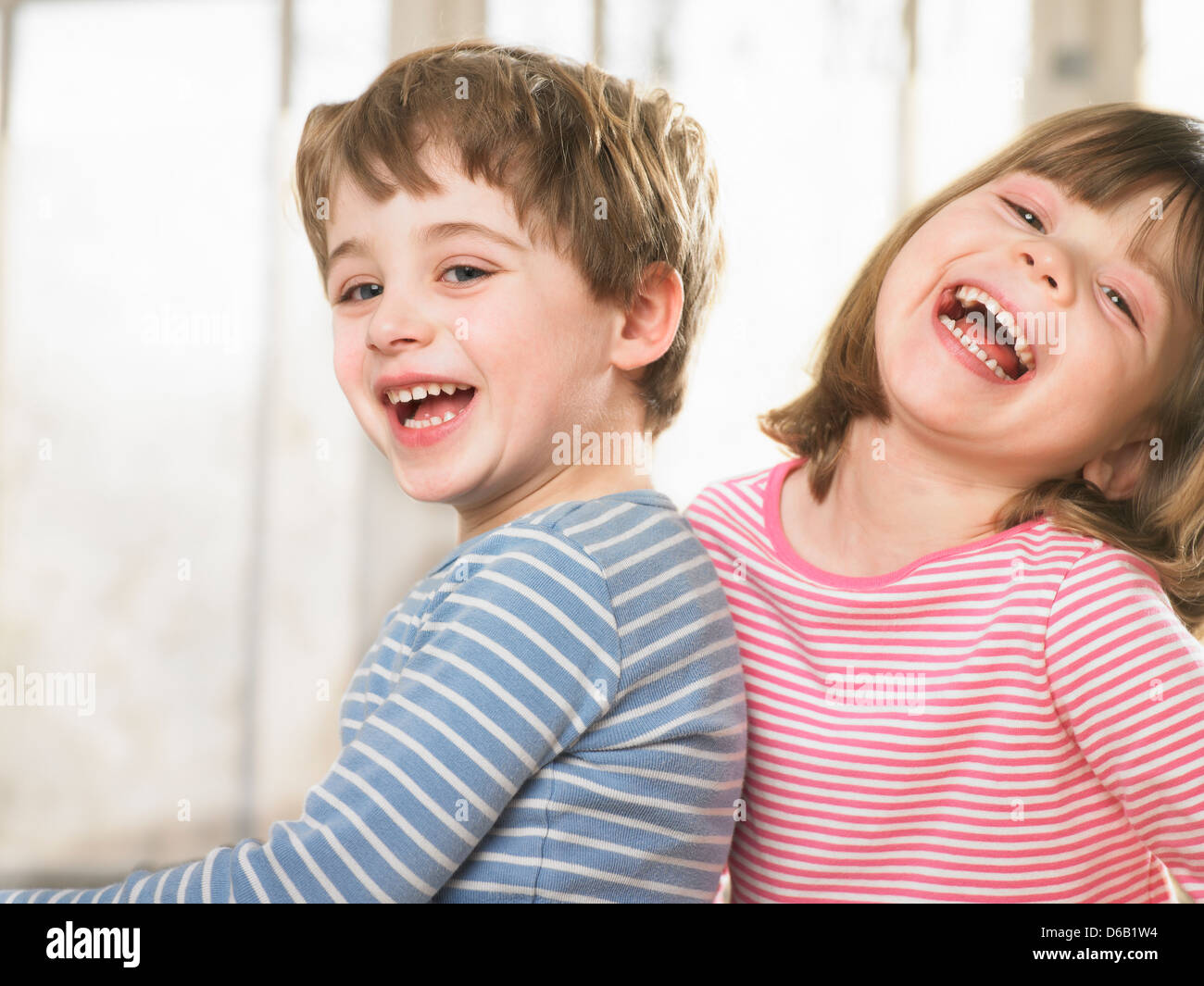 Children smiling together indoors Stock Photo - Alamy