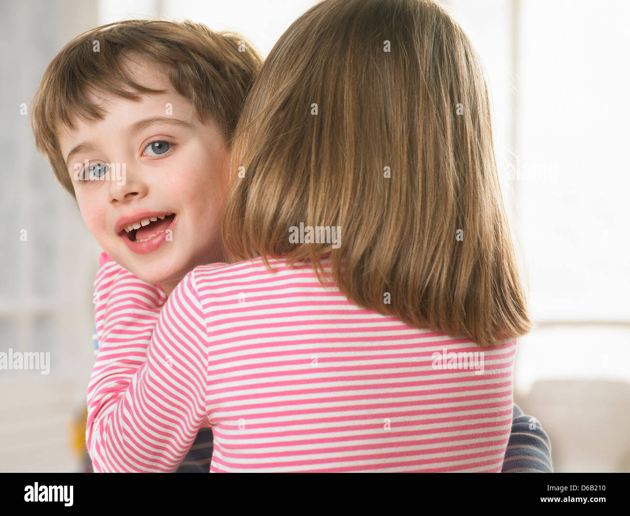 Girl whispering into boys ear hi-res stock photography and images - Alamy
