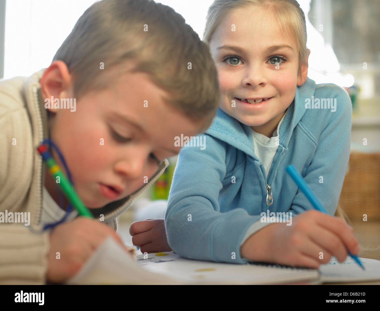 Children drawing together on floor Stock Photo - Alamy