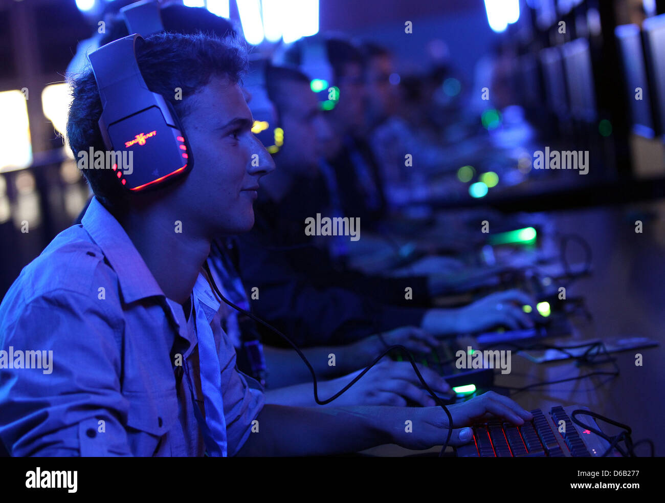 Computer gamers sit in front of screens in Cologne, Germany, 15 August ...