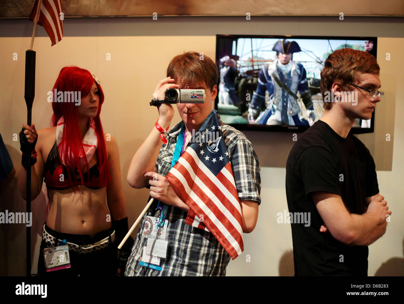 Computer gaming fans queue in front of an exhibition booth in Cologne ...