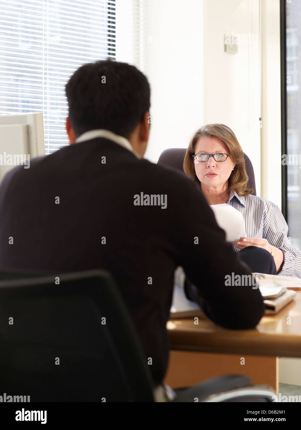 Business people talking at desk Stock Photo - Alamy