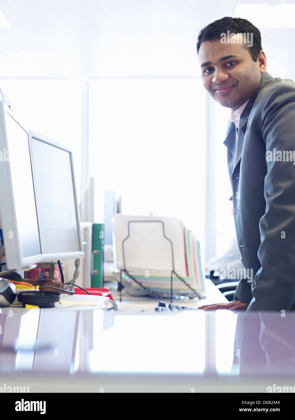 Man smiling at desk hi-res stock photography and images - Alamy
