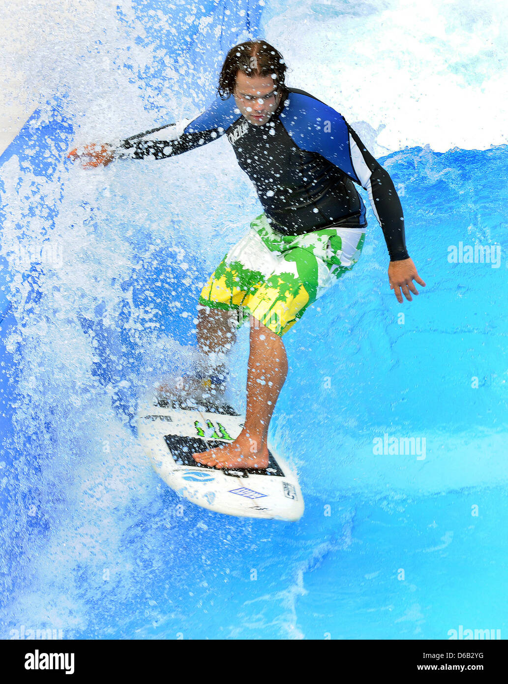 Surfing teacher Ali glides over an artificial wave at Snowdome near ...