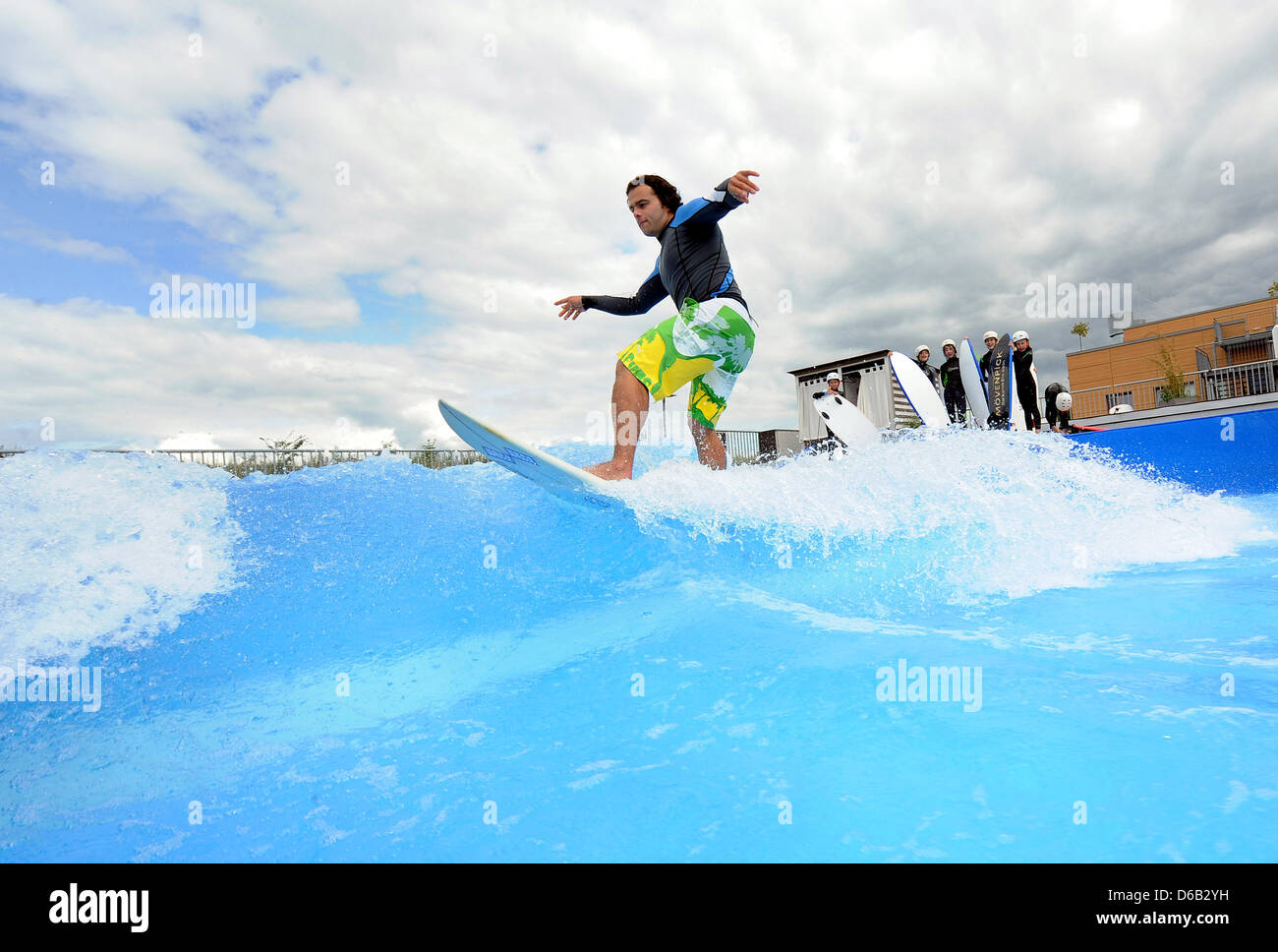 Surfing teacher Ali glides over an artificial wave at Snowdome near ...