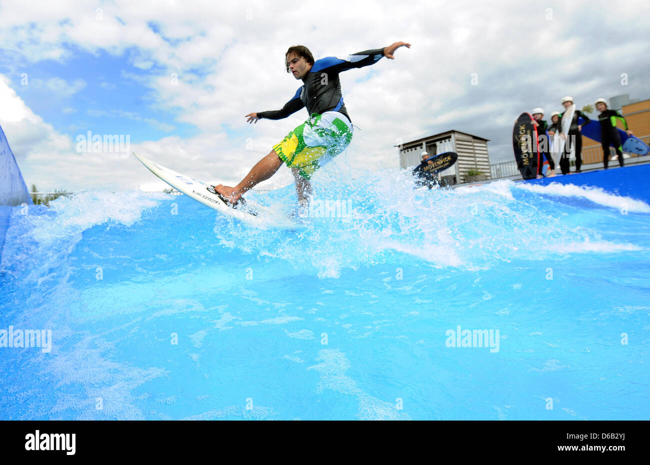 Surfing teacher Ali glides over an artificial wave at Snowdome near ...