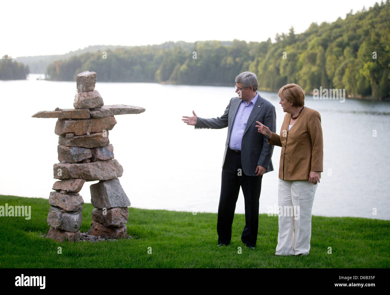Canadian Premier Stephen Harper talks to German Chancellor Angela ...