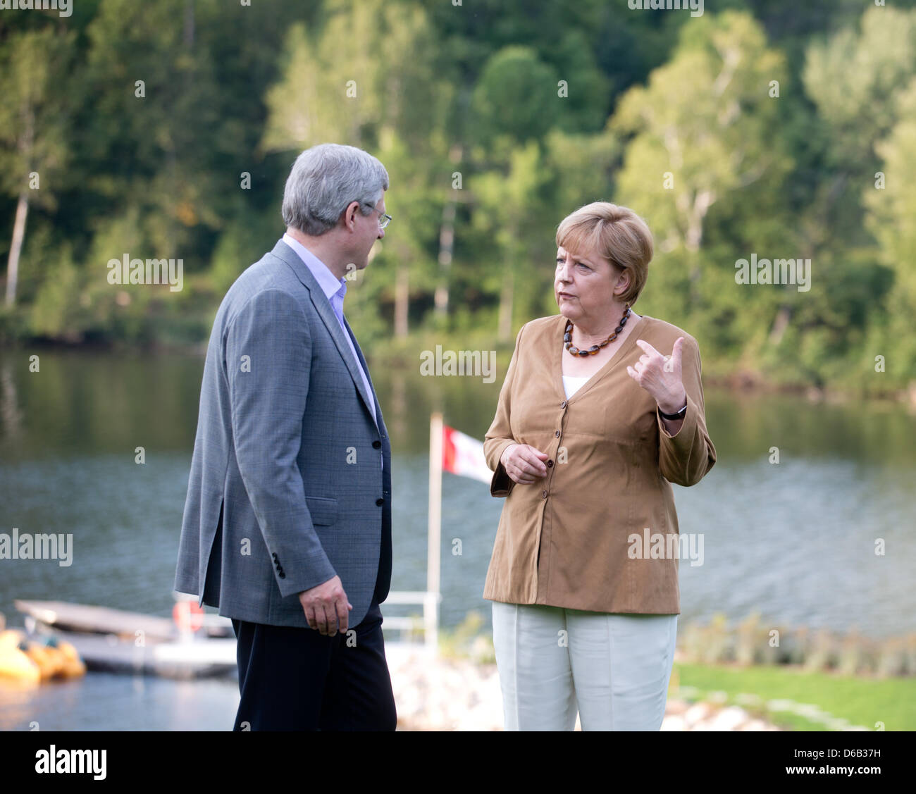 Canadian Premier Stephen Harper talks to German Chancellor Angela ...