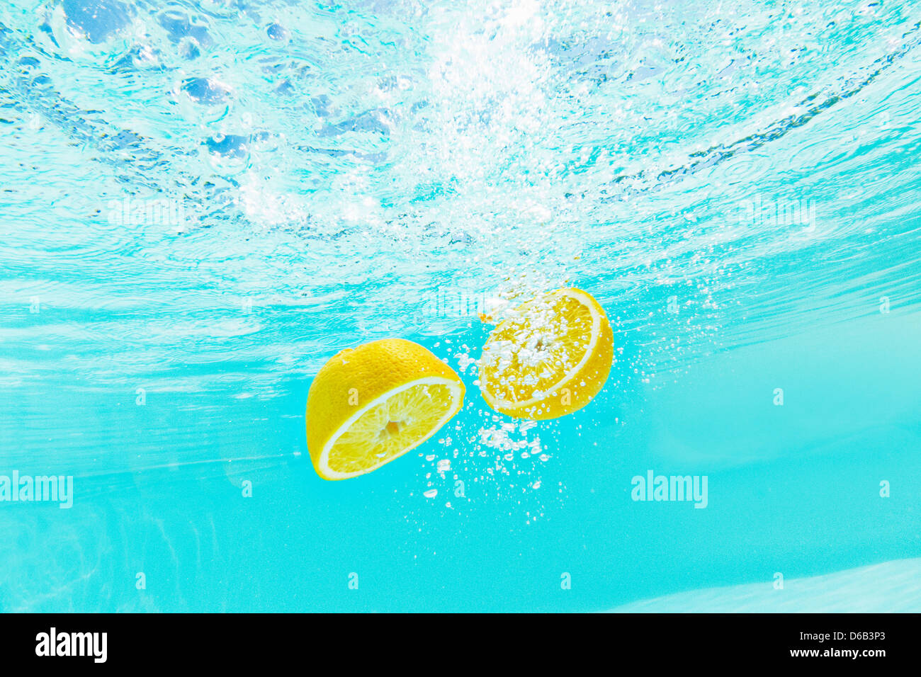 Sliced lemon splashing into water Stock Photo - Alamy