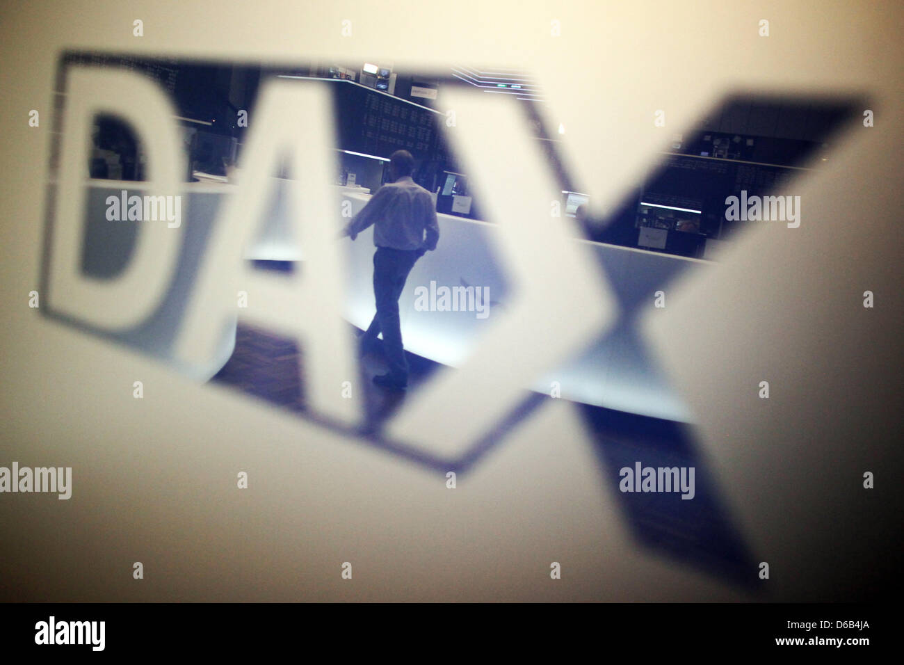 A trader is reflected in the logo of the DAX at the stock market in ...