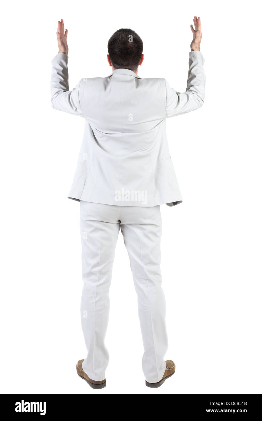 Back view of shocked and scared young business man. Holds hands upwards ...