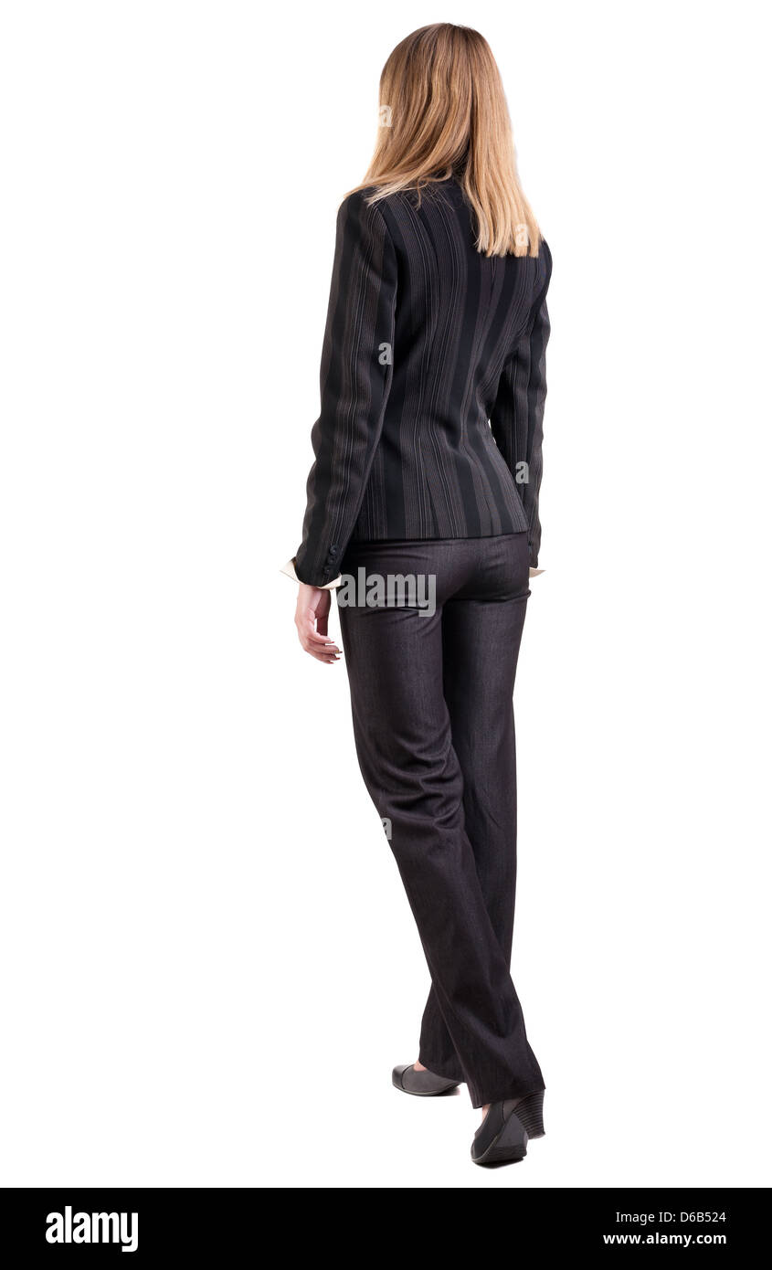 walking business woman. back view. going young girl in suit. Rear view ...