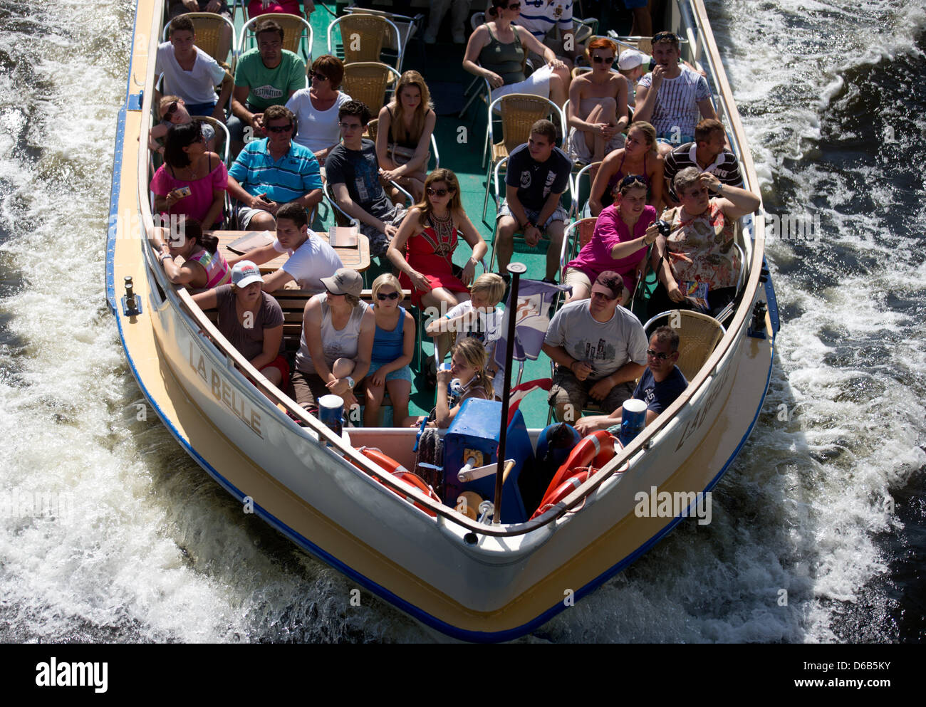Sightseers enjoy the sunshine and the summerly temperatures on a boat ...