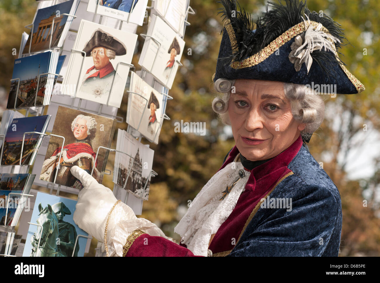 Frederick the Great actor, a Historiale actor, poses next to a postcard ...